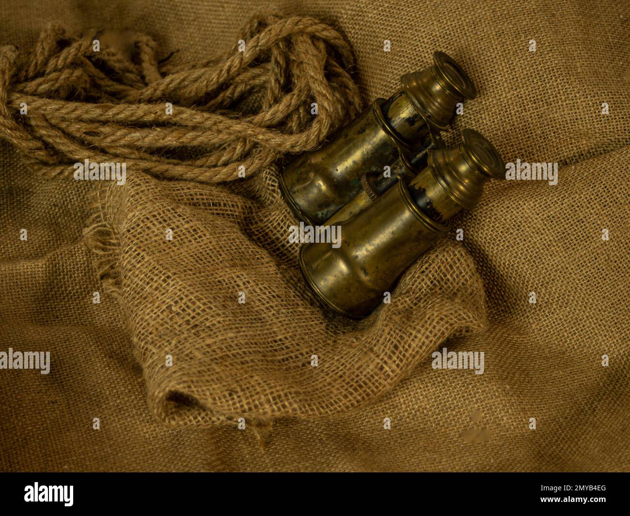 Still life of adventure objects for exploration binoculars, compass ...