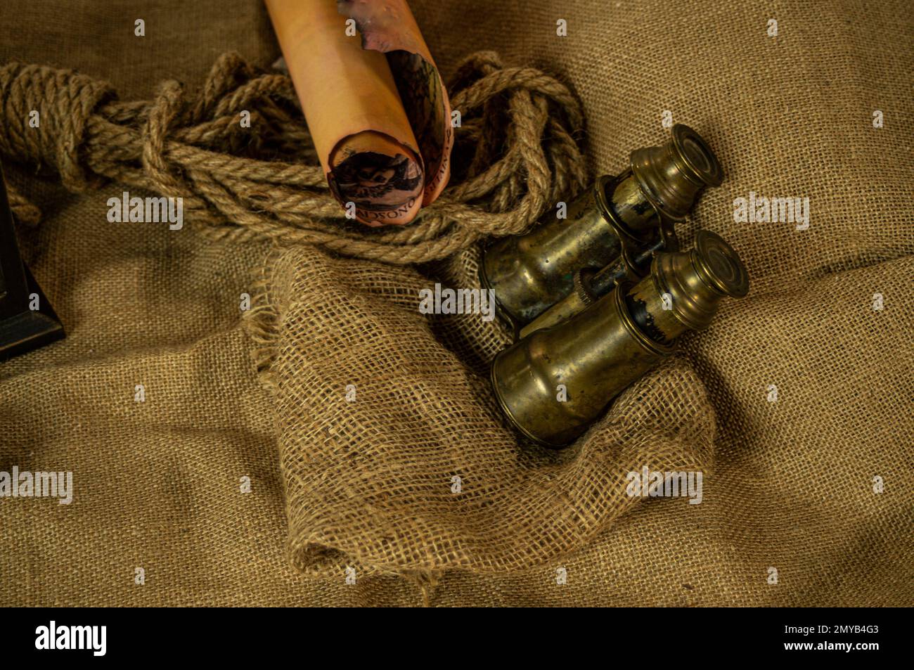 Still life of adventure objects for exploration binoculars, compass ...