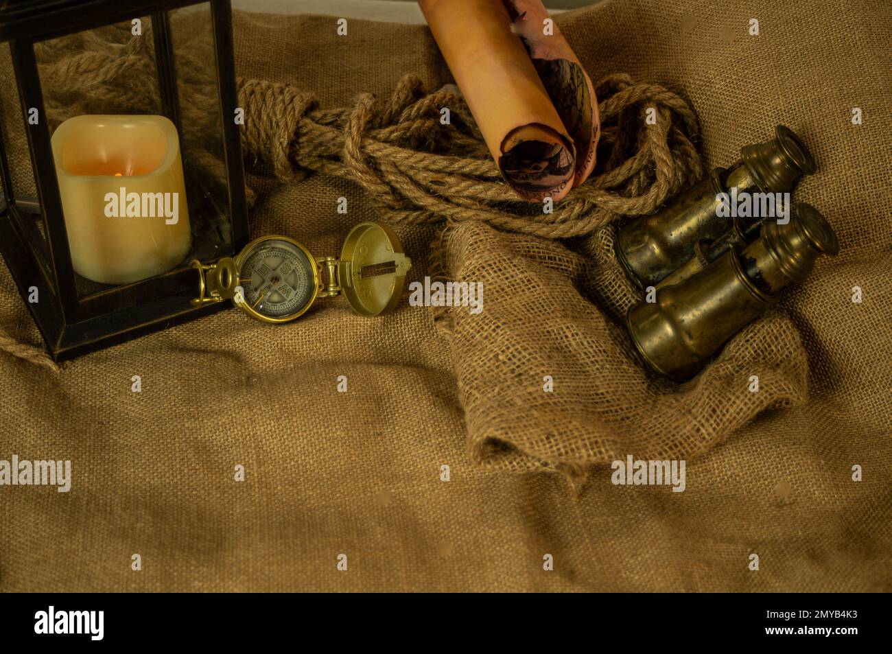 Still life of adventure objects for exploration binoculars, compass ...