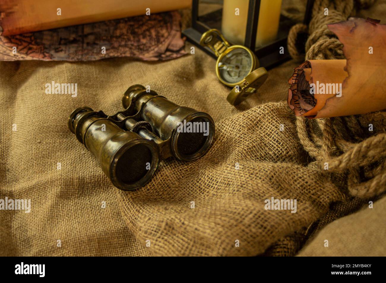 Still life of adventure objects for exploration binoculars, compass ...