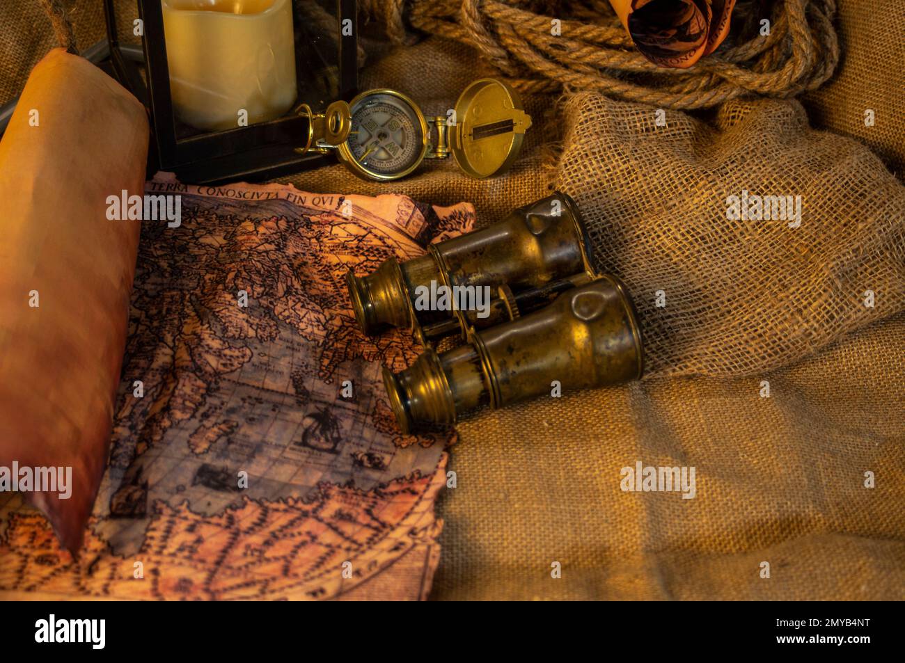 Still life of adventure objects for exploration binoculars, compass ...