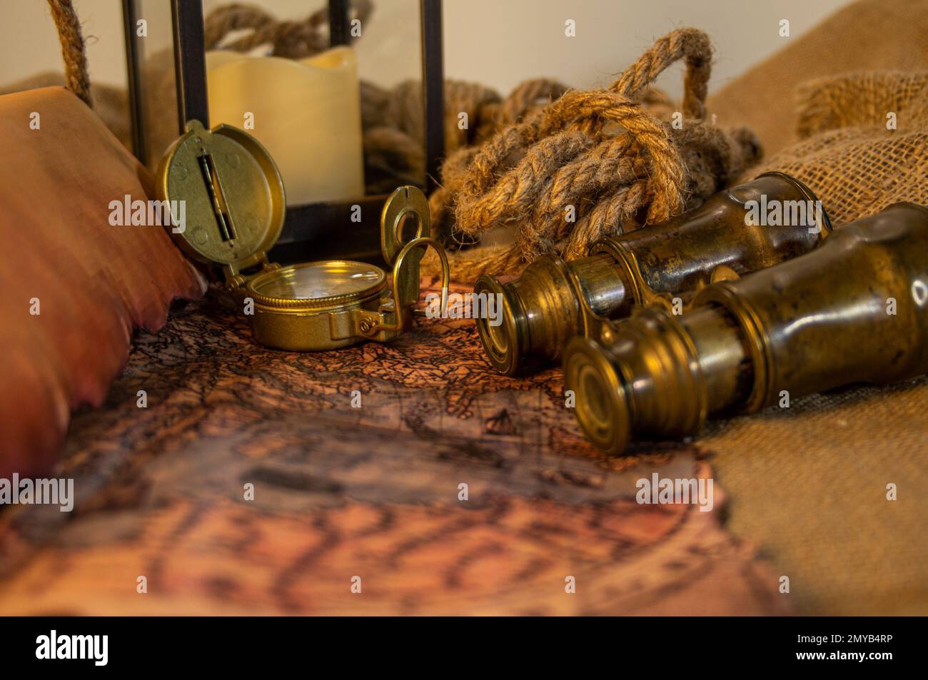 Still life of adventure objects for exploration binoculars, compass ...