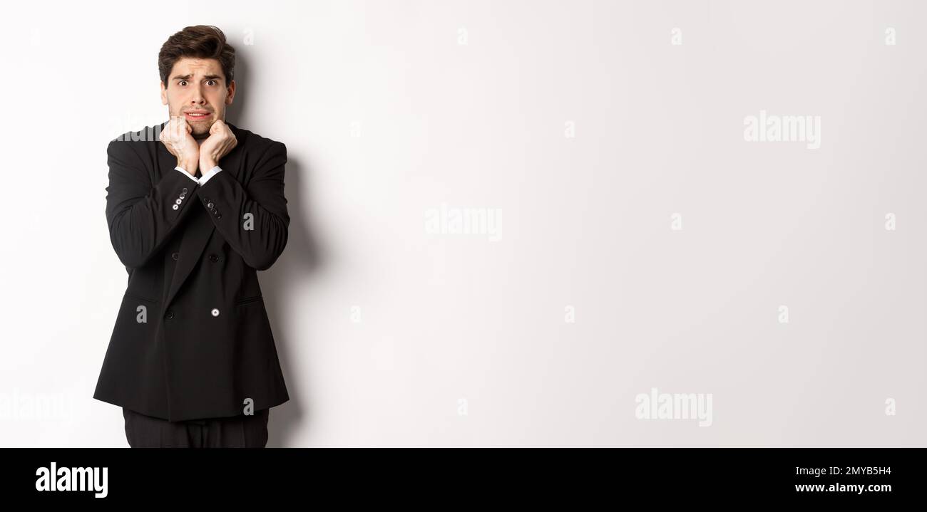 Image of scared and insecure young businessman in suit, trembling from ...