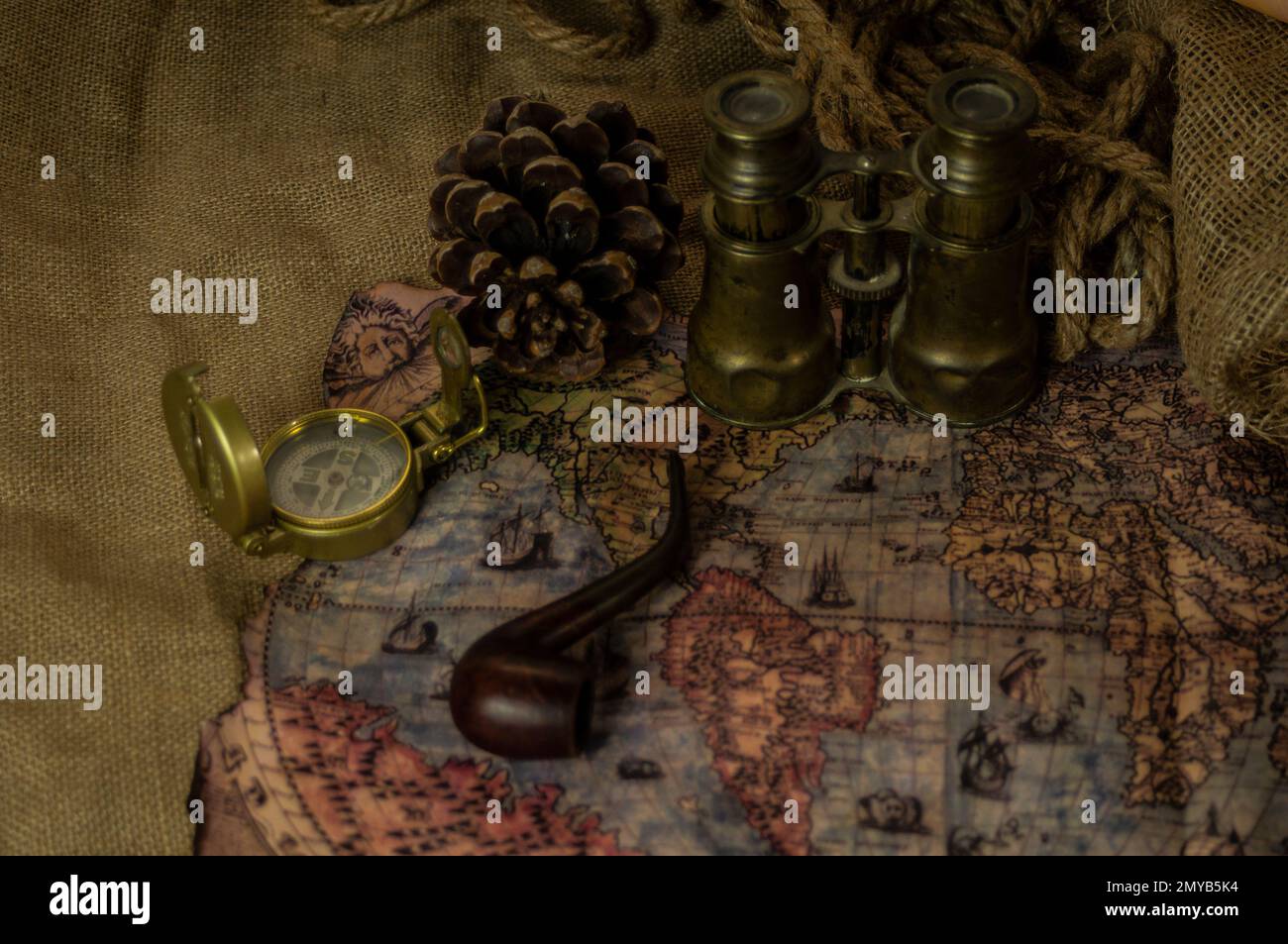 Adventure and exploration scroll along with antique brass binoculars ...