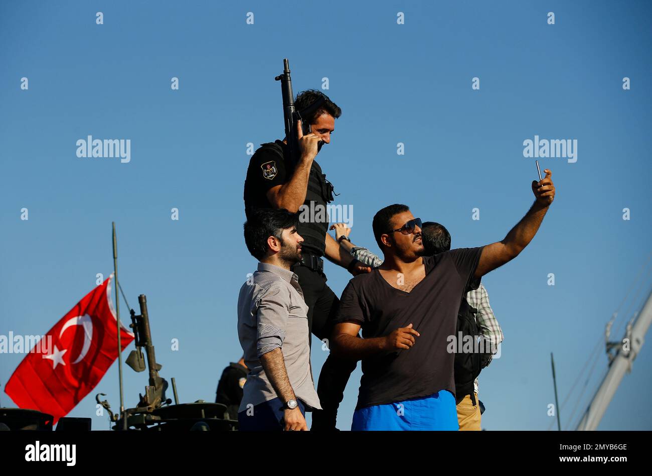 A Turkish man takes a selfie with a Turkish police officer, loyal to ...