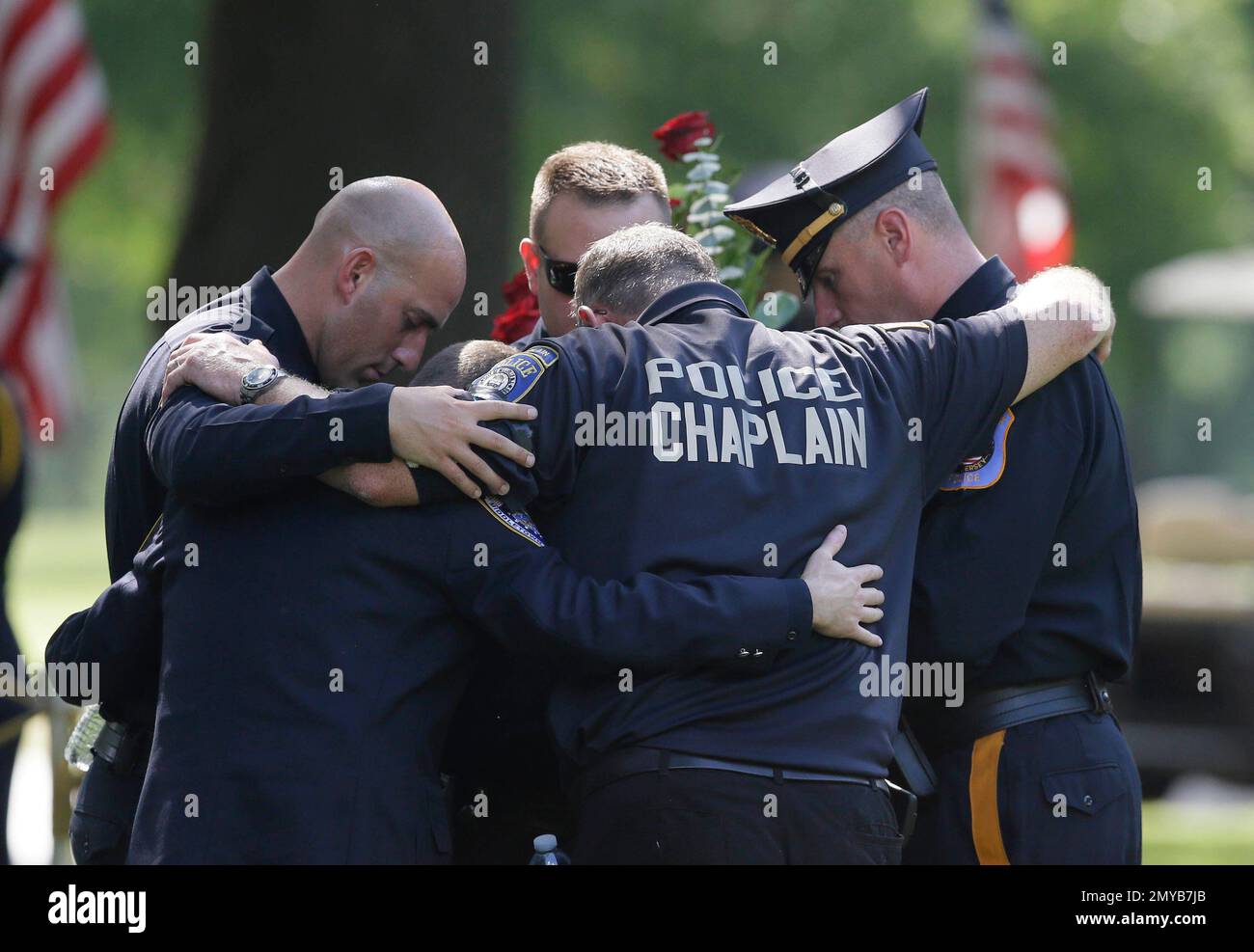 Law enforcement officers embrace each other as they pray after the ...