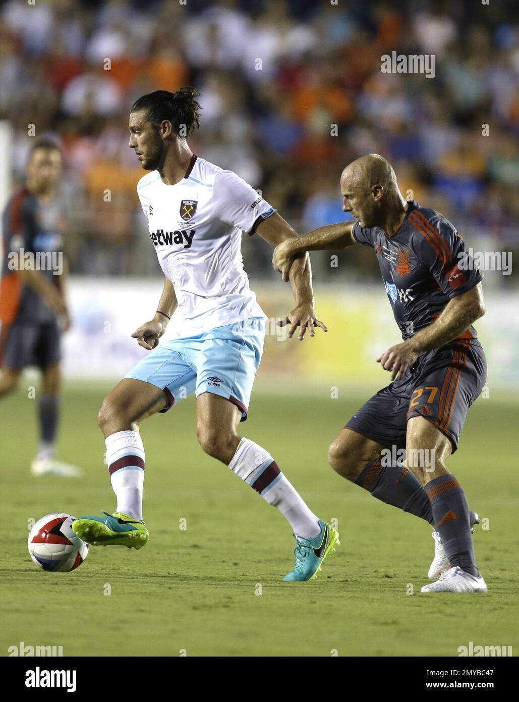 West Ham United's Andy Carroll Carolina Railhawks' Simon Mensing battle ...