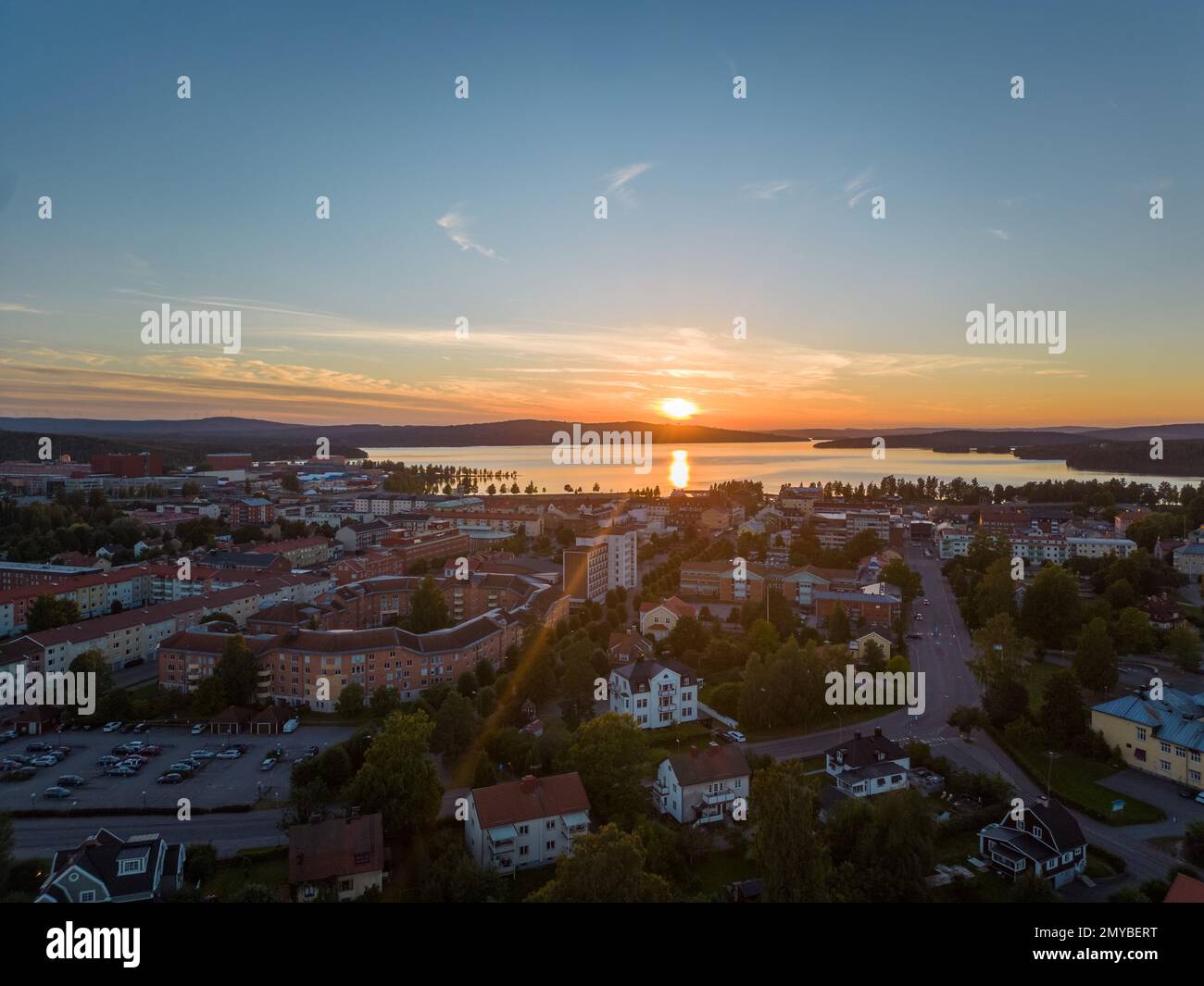Sunset at a lake and a town in Sweden Stock Photo - Alamy