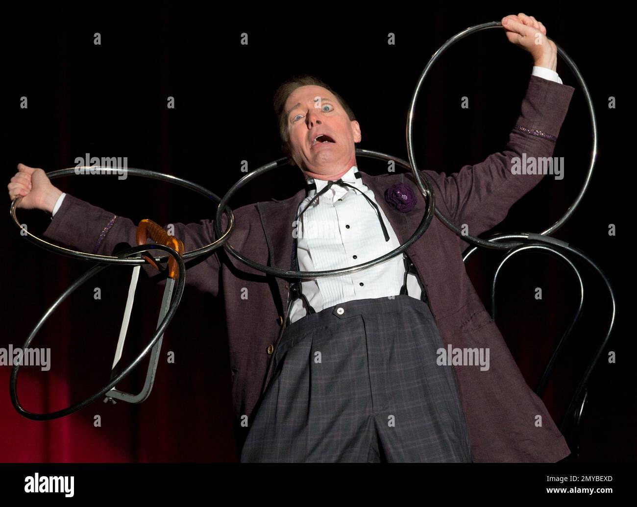 Charlie Frye, "The Eccentric," performs with metal hoops during a ...