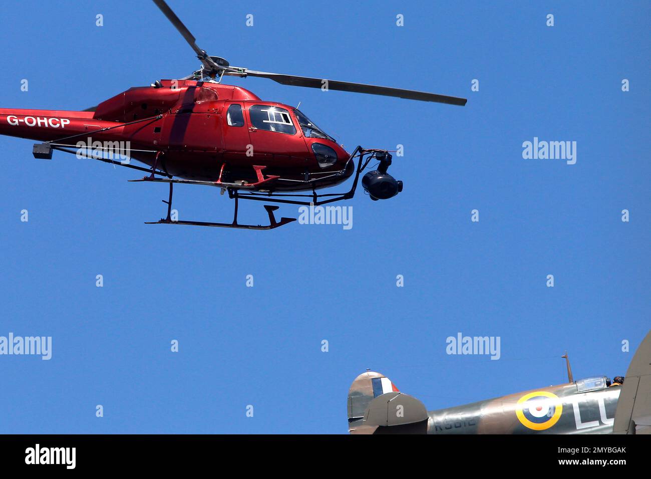 A fighter plane in the air over the beach during filming a scene for ...