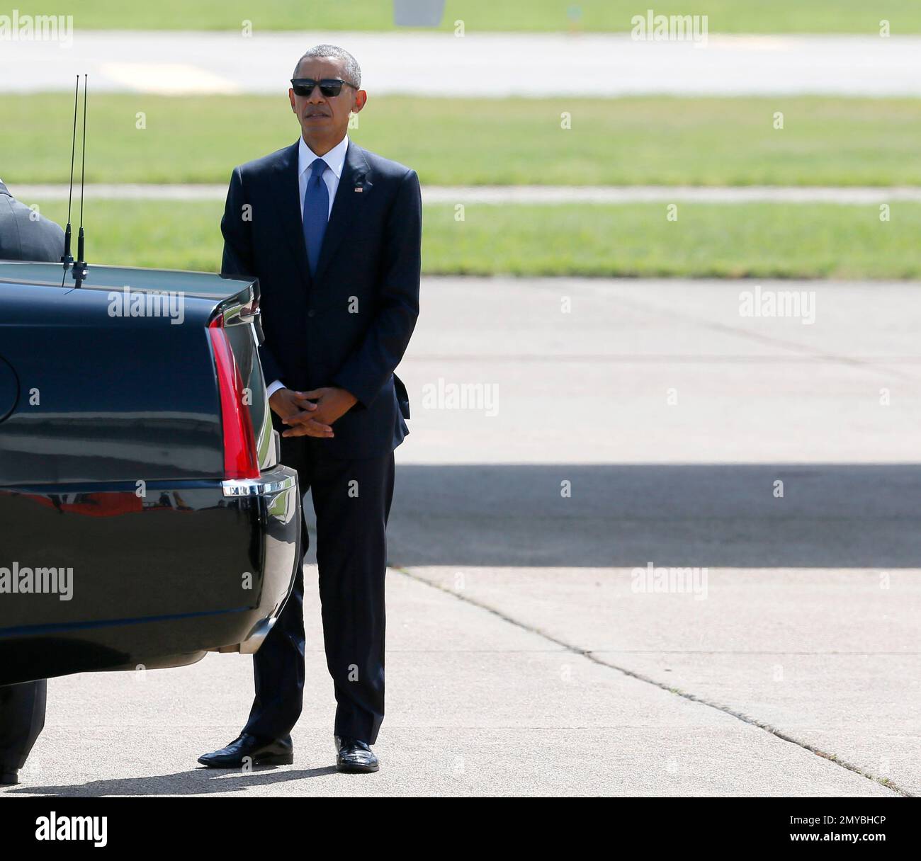 President Barack Obama stands behind his limousine before leaving ...