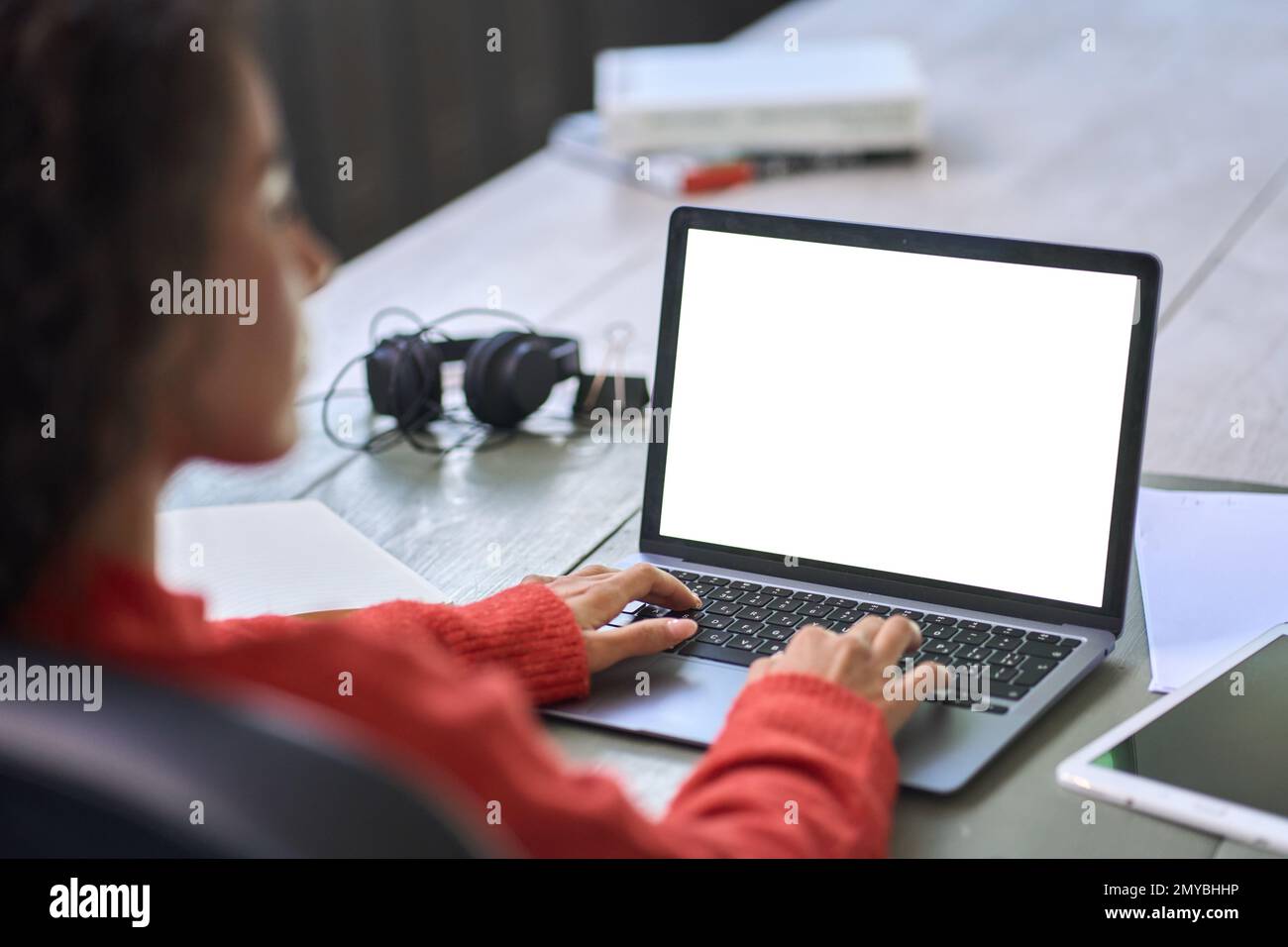 Woman elearning looking at mockup screen using laptop, over shoulder ...
