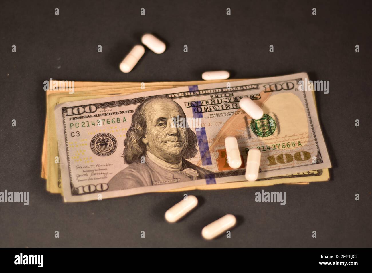 100 dollar bill and different kind of drugs on a black background Stock ...
