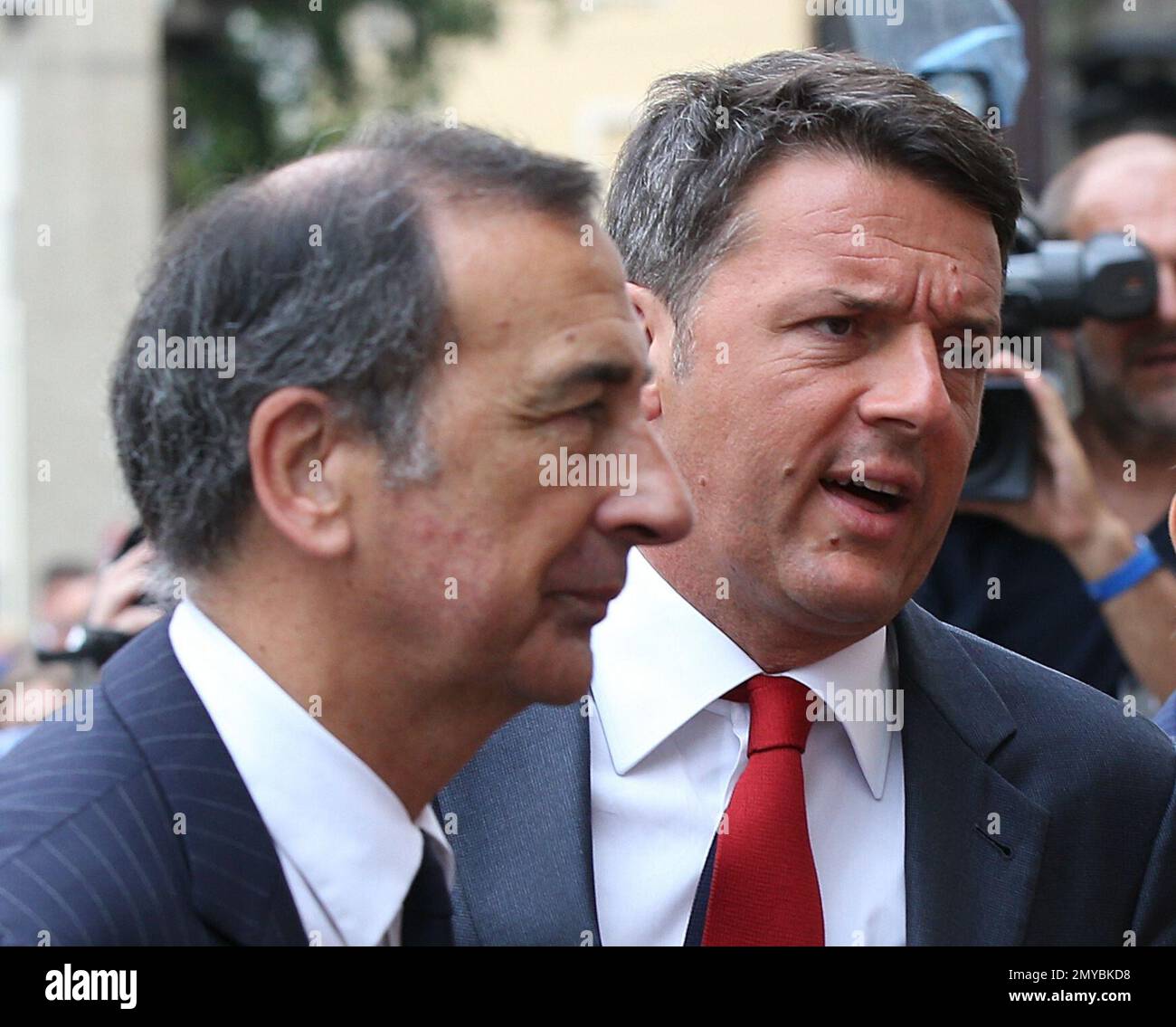 Italian premier Matteo Renzi, right, is flanked by Milan's mayor Matteo ...