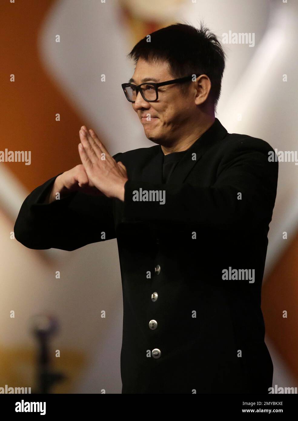 Chinese actor Jet Li, left, performs traditional "fist and palm" salute ...