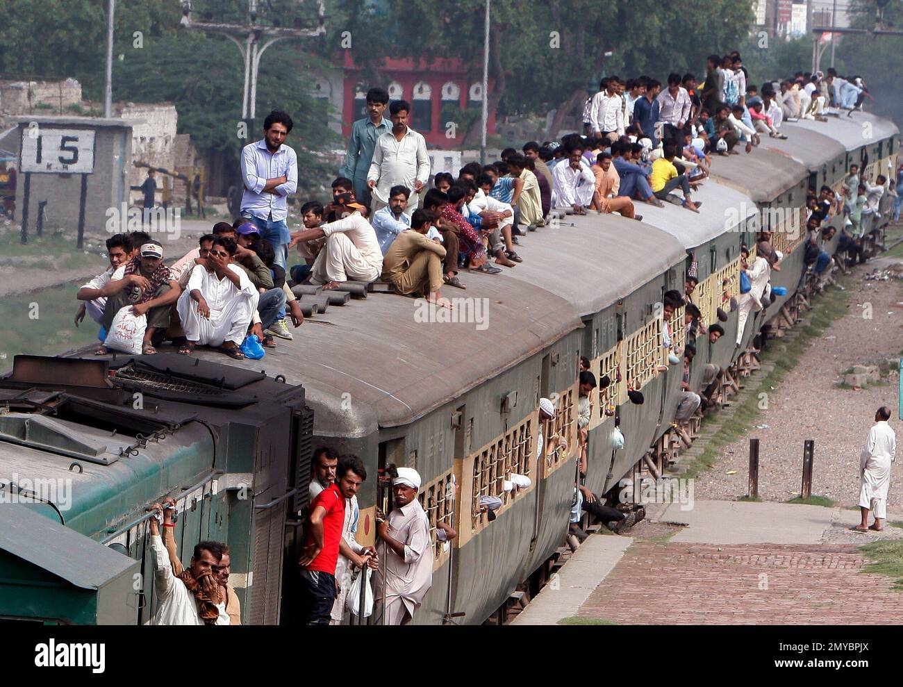 Pakistani passengers ride on crowded train returning from their ...