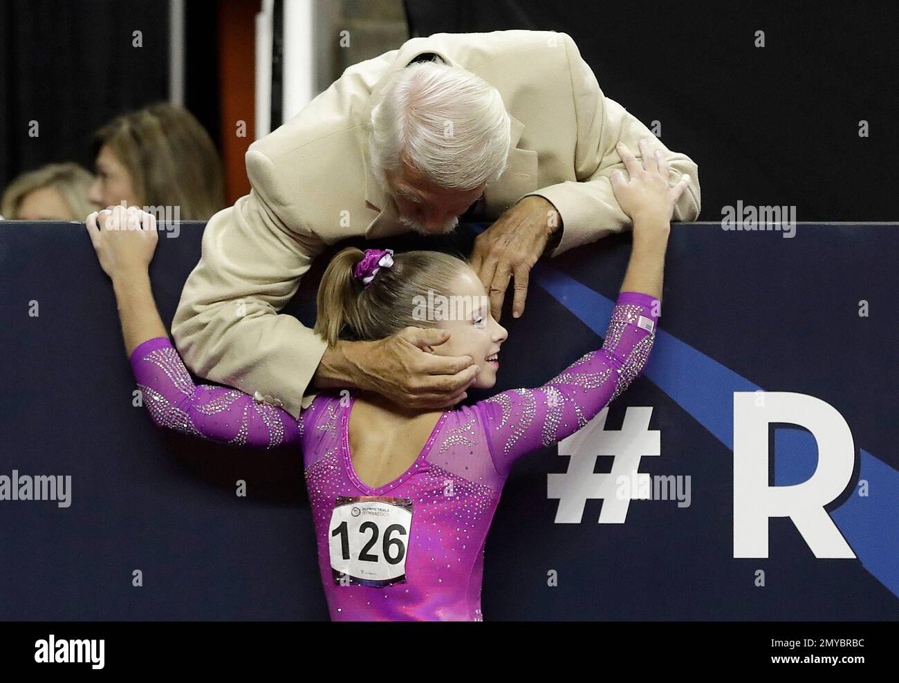 Ragan Smith, bottom, is hugged by Béla Károlyi after competing on the ...