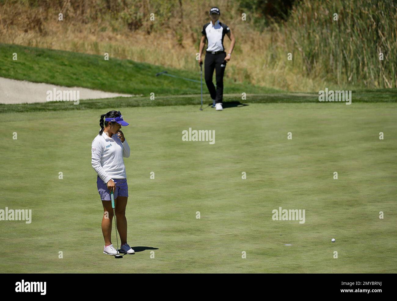 Lydia Ko, left, of New Zealand, reacts after missing a birdie putt on ...