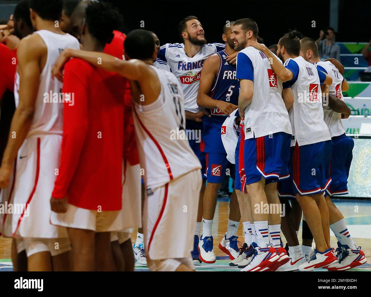 French basketball players, right, celebrate following their 83-74 win ...