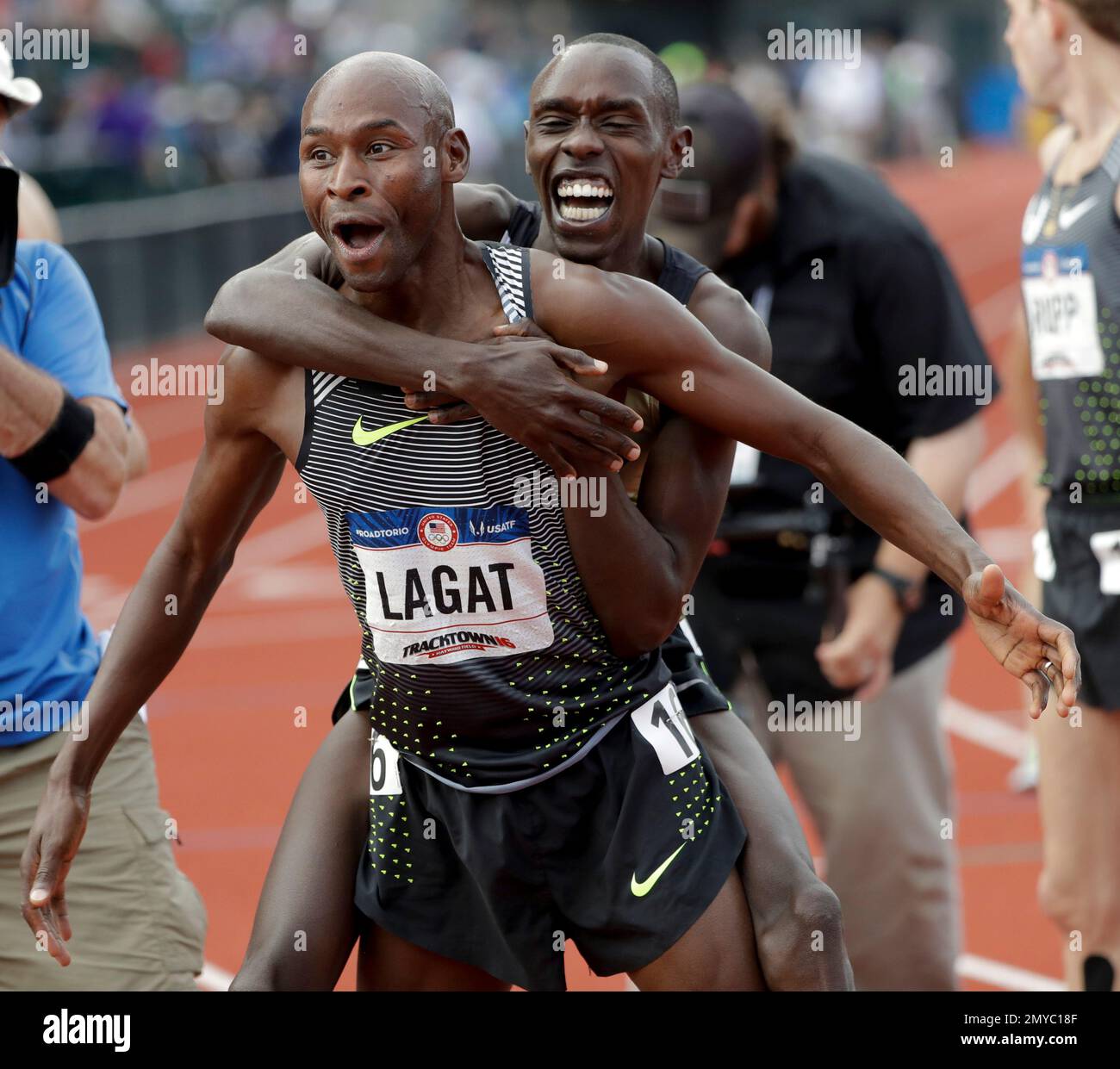 Bernard Lagat, left, celebrates his win in the finals of the men's 5000 ...