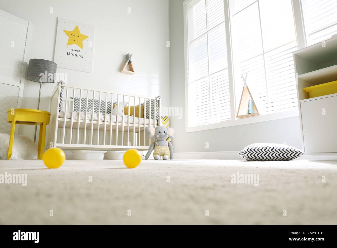 Cute baby room interior with crib and big window, low angle view Stock ...