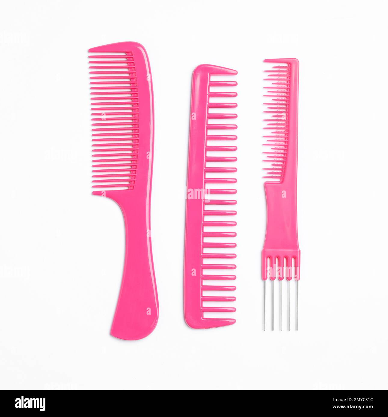 Pink hair combs on white background, top view Stock Photo - Alamy