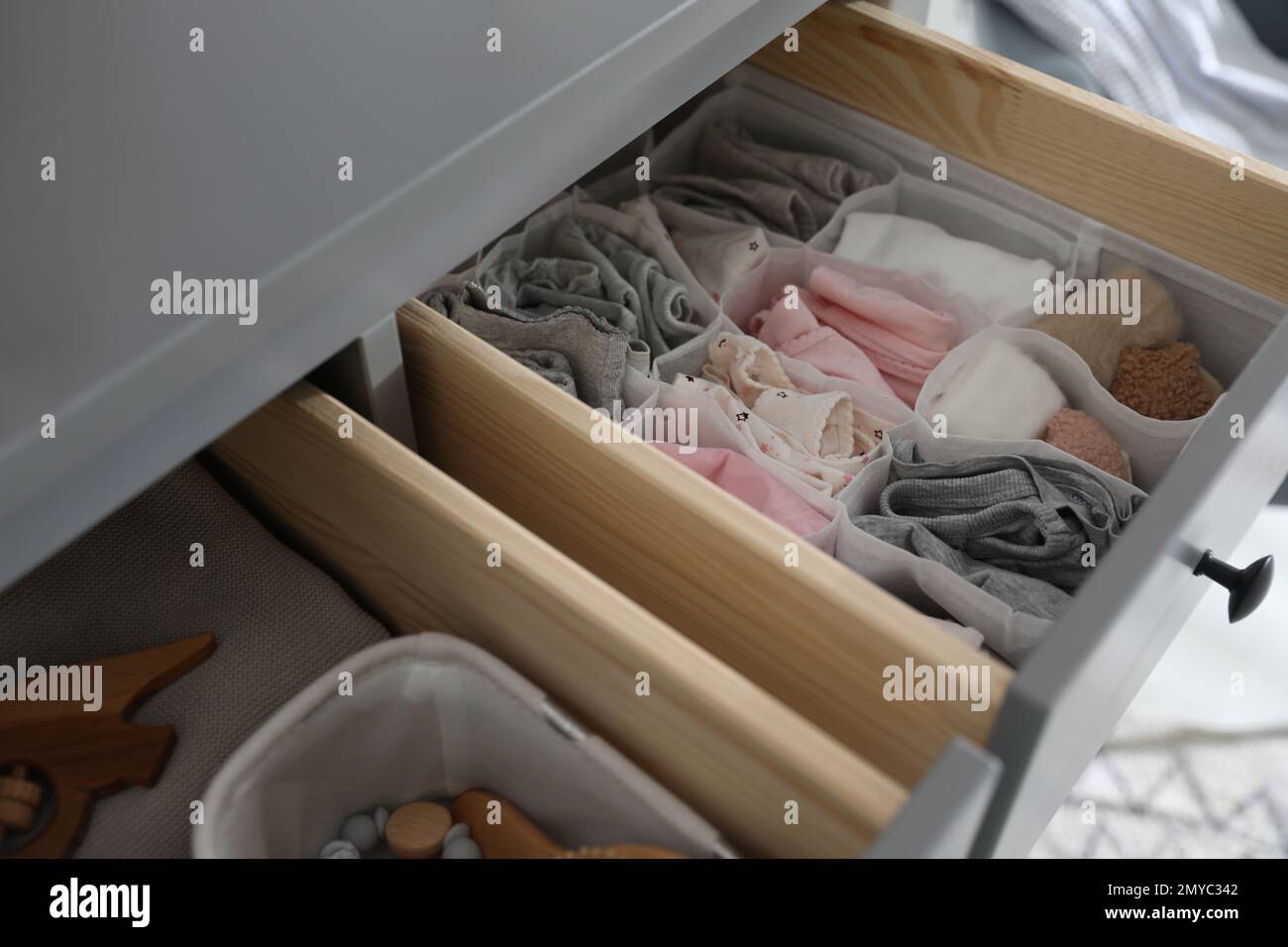 Open cabinet drawer with clothes in child room Stock Photo - Alamy