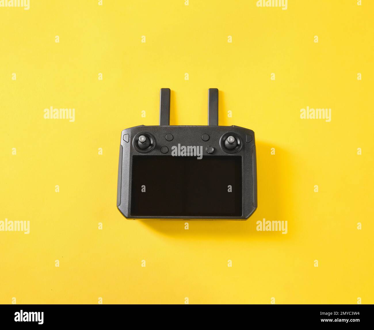New modern drone controller on yellow background, top view Stock Photo ...
