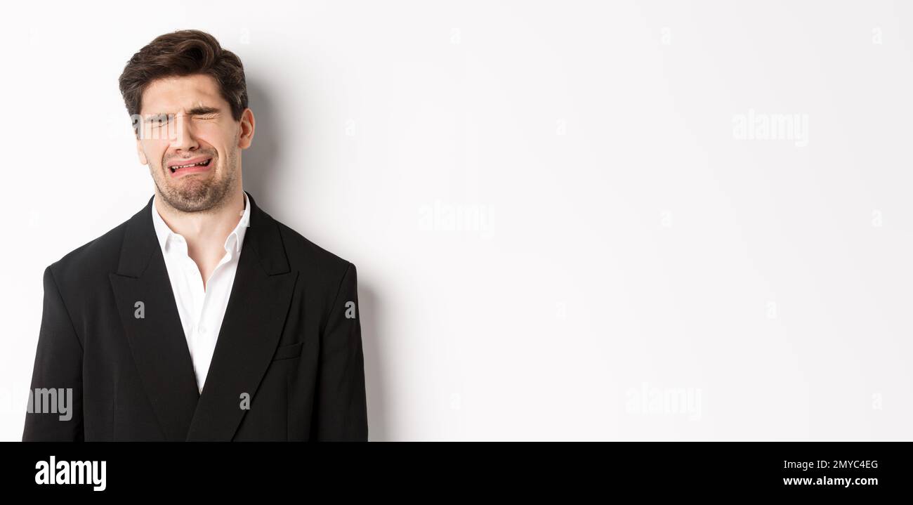 Close-up of miserable man in suit, crying and sobbing, feeling sad ...