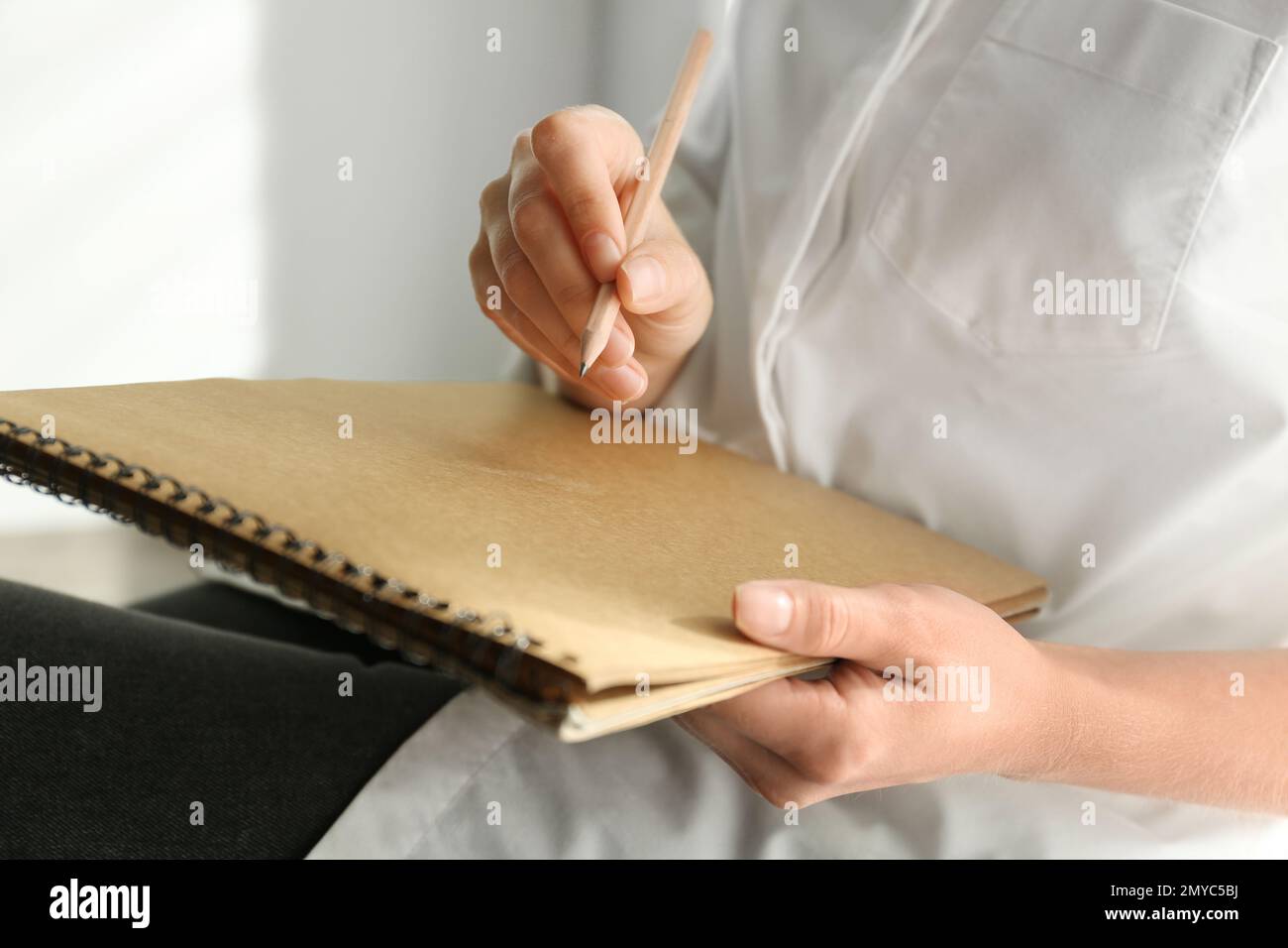 Woman drawing with pencil in notepad, closeup Stock Photo - Alamy