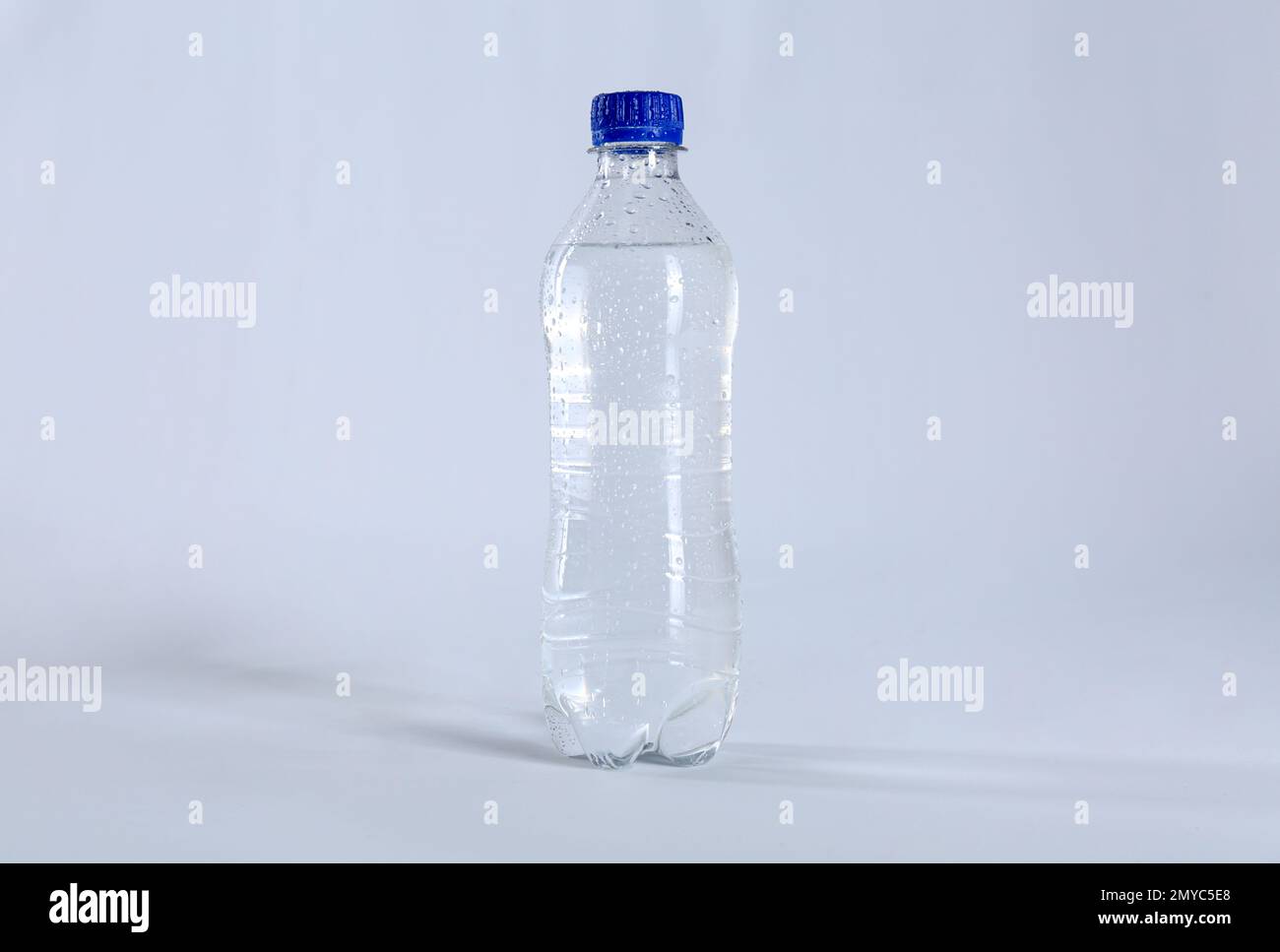 Plastic bottle of pure water on light background Stock Photo - Alamy