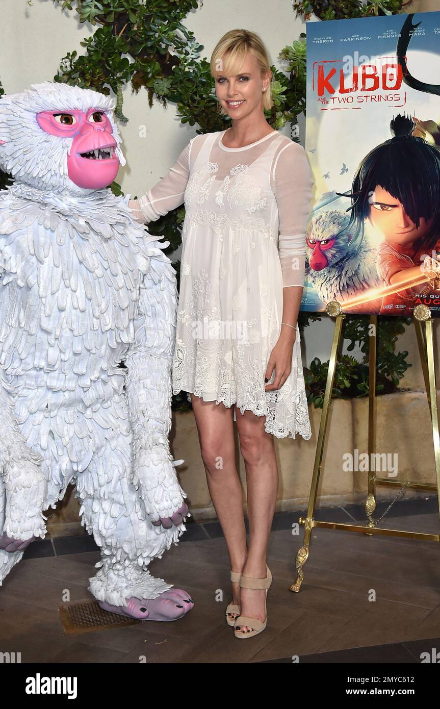 Charlize Theron poses with a character from the movie during a ...