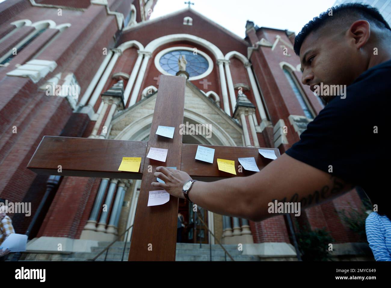 Misael Gonzalez, of Dallas, places a prayer onto a crucifix before ...