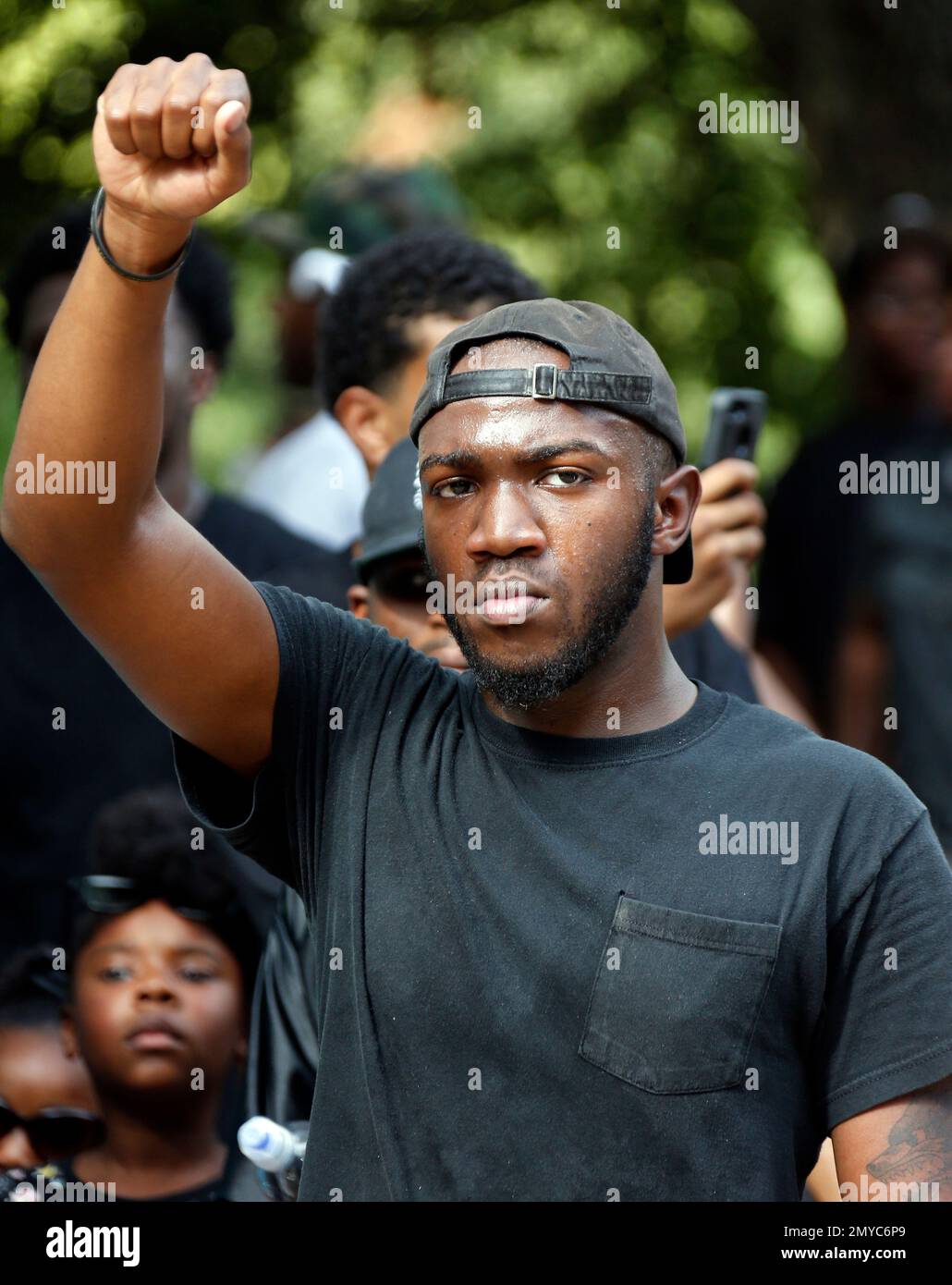Devin Cousin, 20, of Florence, Miss., raises his fist as he and about ...