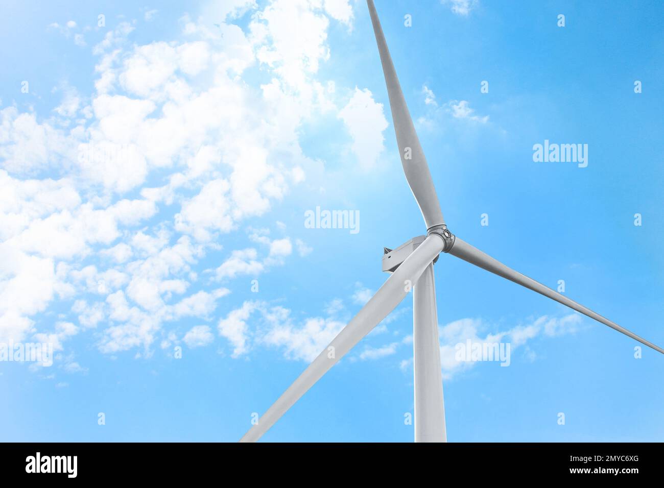 Modern windmill against sky with clouds, space for text. Energy ...