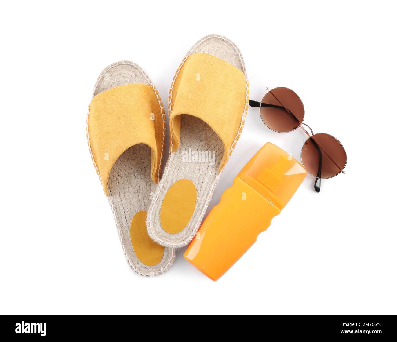 Shoes, sunscreen and sunglasses on white background, top view. Beach ...