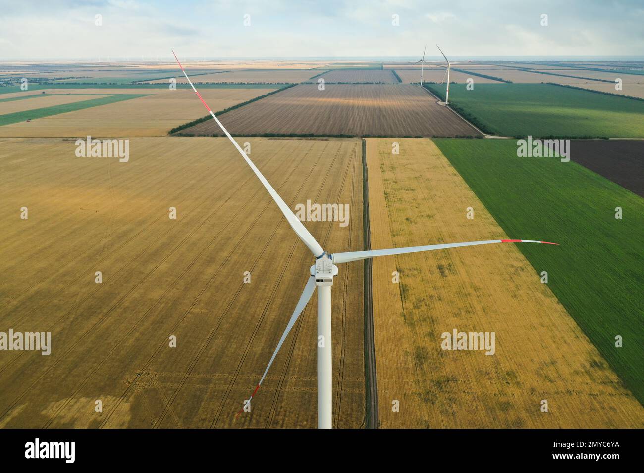 Modern windmill in wide field. Energy efficiency Stock Photo - Alamy
