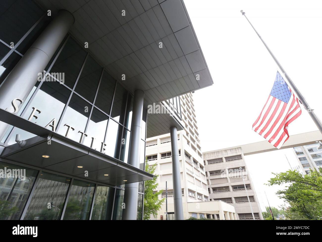 A U.S. flag flies at half-staff outside Seattle Municipal Court next to ...