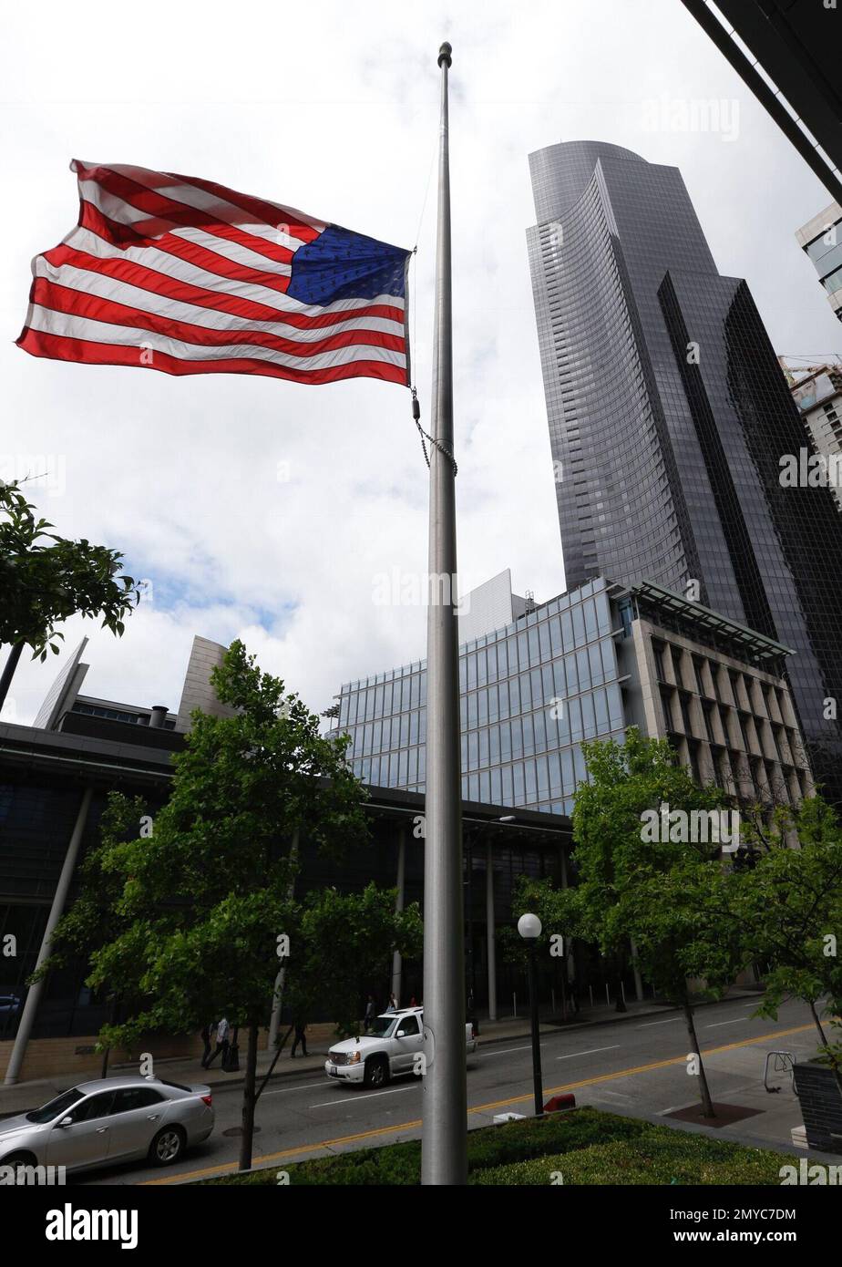 A U.S. flag flies at half-staff outside Seattle Municipal Court next to ...