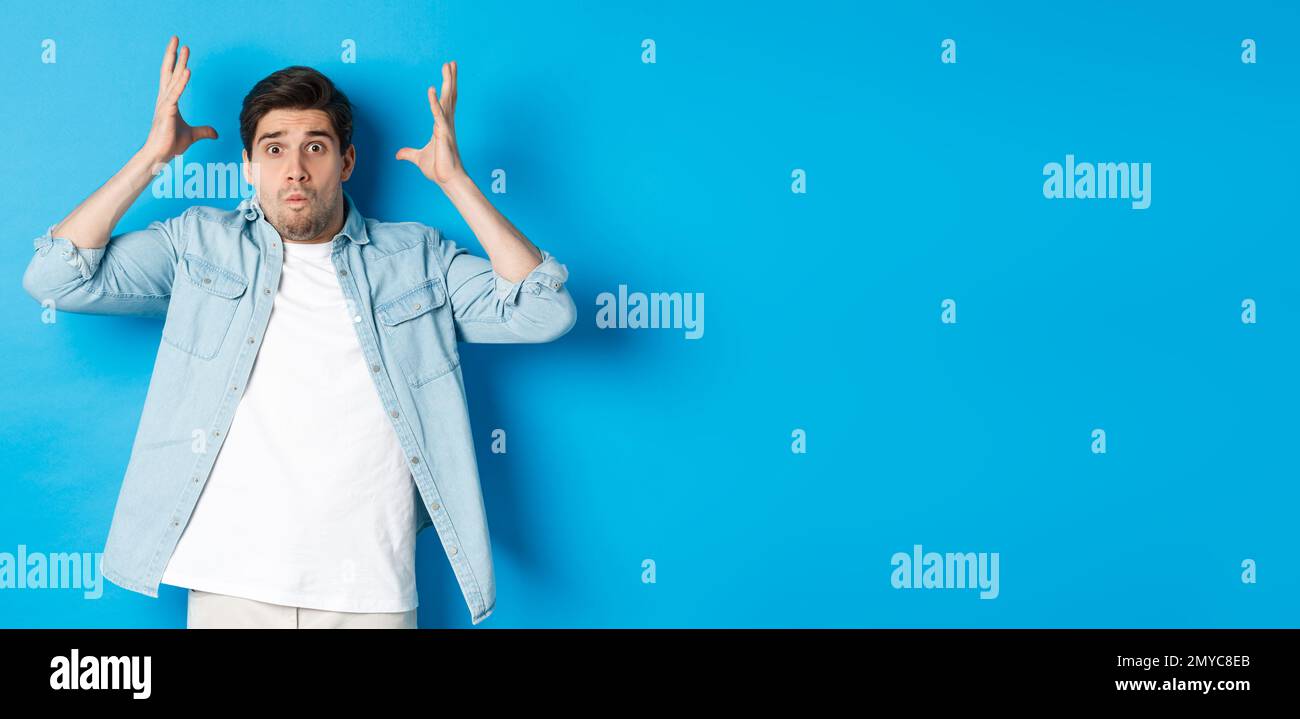 Distressed guy showing mind blowing gesture, looking frustrated and ...