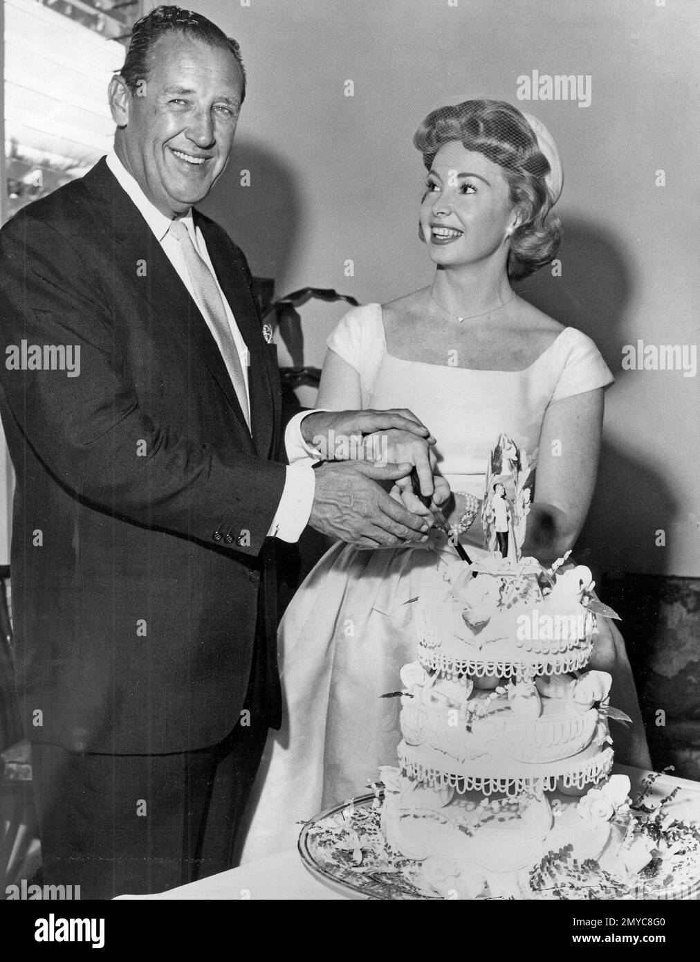 Actress Audrey Meadows and her new husband Robert F. Six, cut into a ...