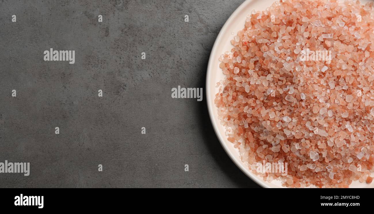 Pink himalayan salt on grey table, top view. Space for text Stock Photo ...