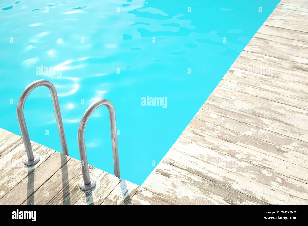 Ladder with grab bars in outdoor swimming pool Stock Photo - Alamy