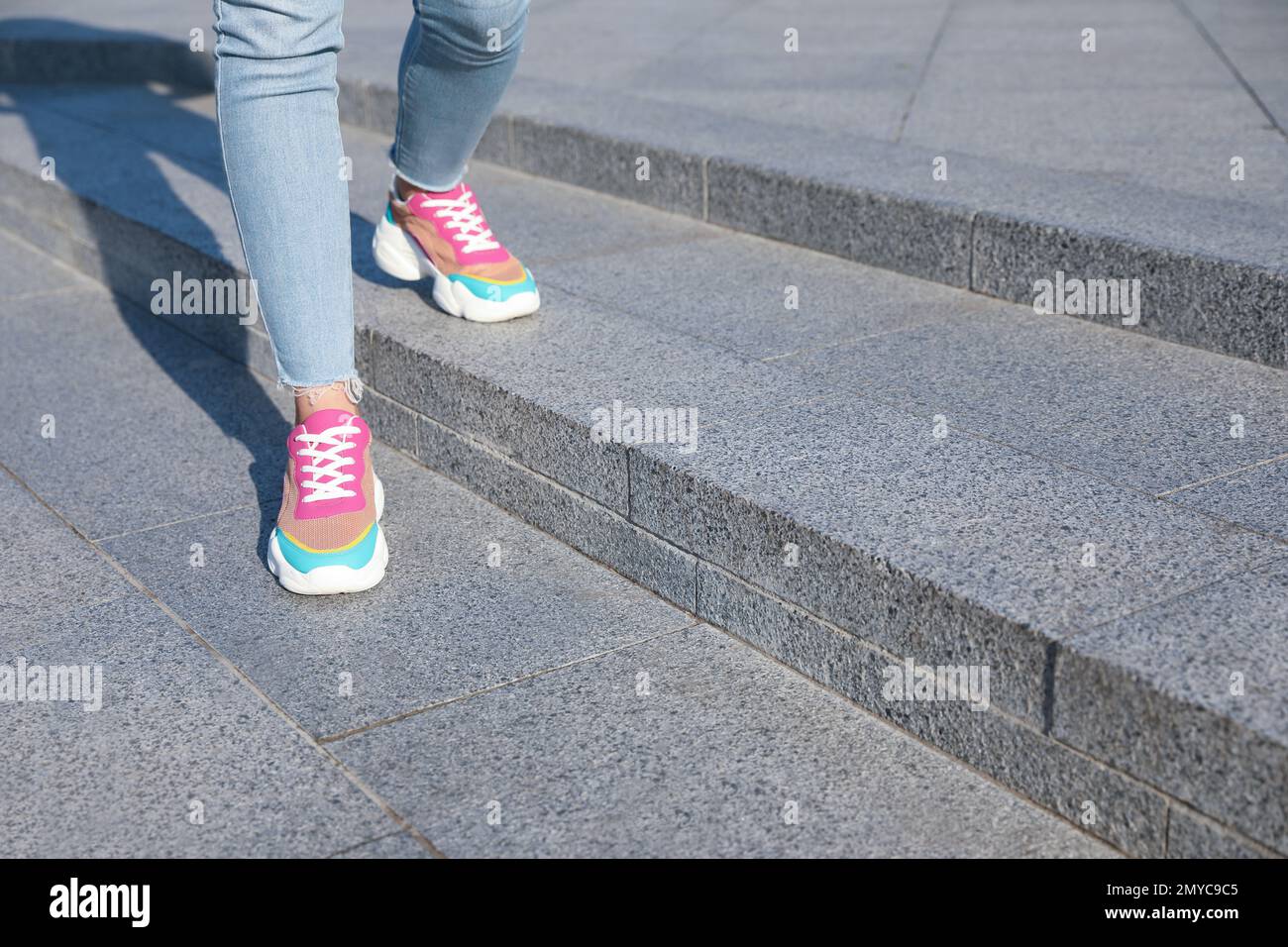 Woman on stairs outdoors, closeup with space for text. Choosing way ...