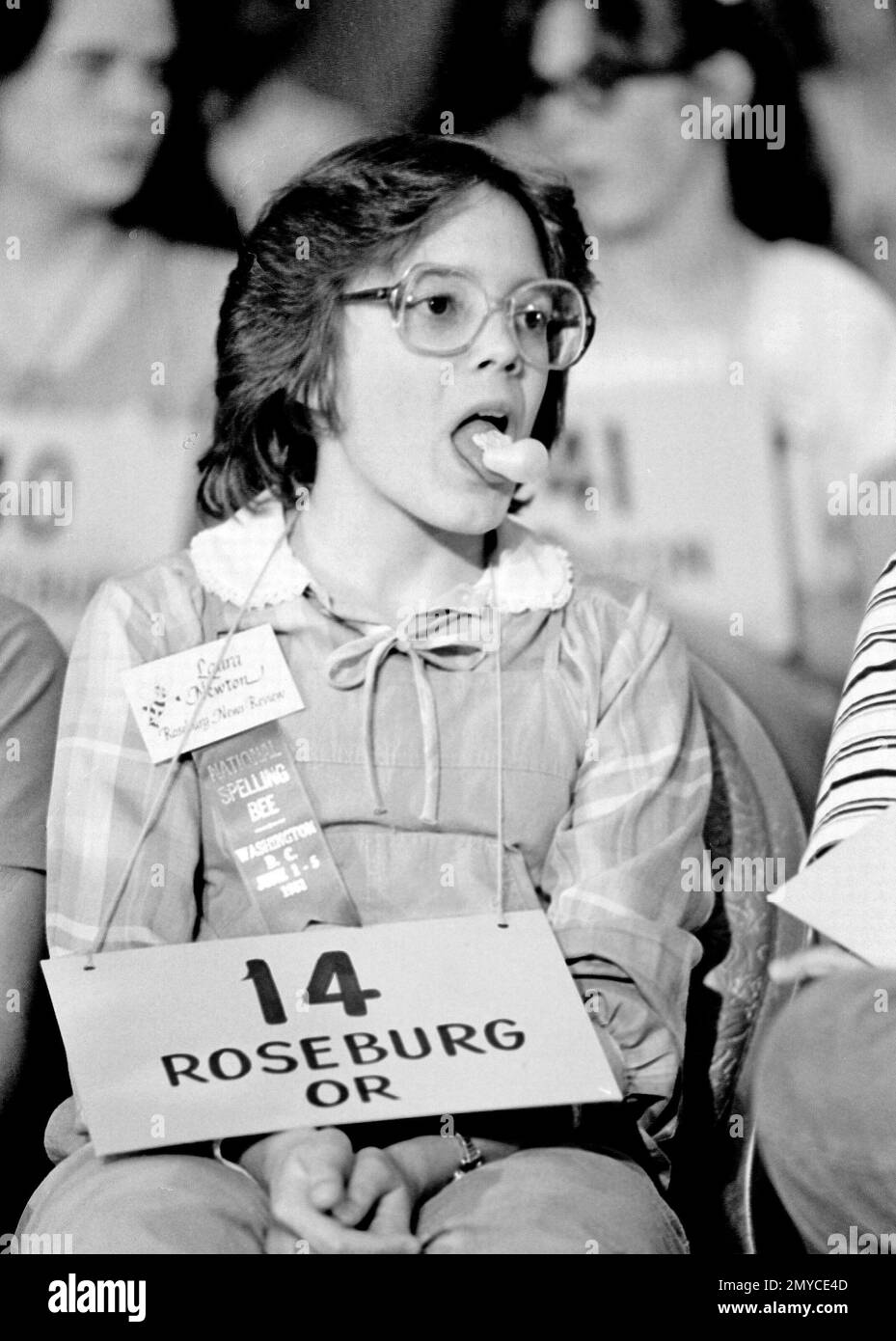 Laura Newton of Roseburg, Ore., passes the time blowing bubbles during ...