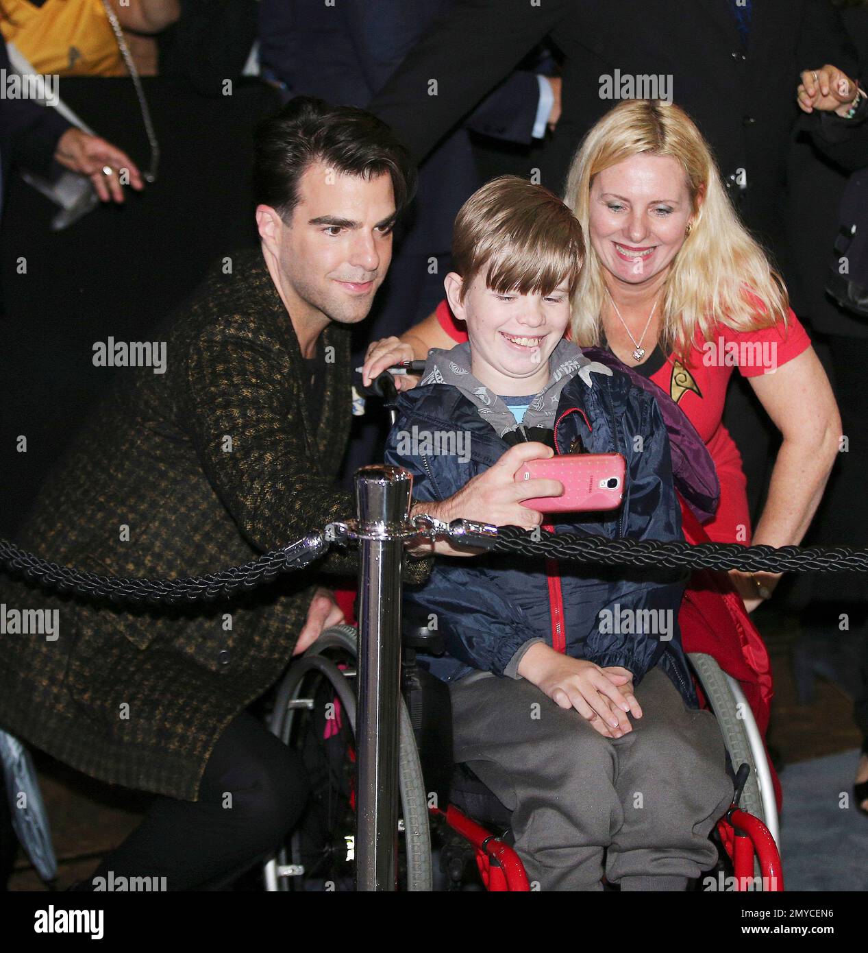 Actor Zachary Quinto, left, has a selfie taken with two fans as he ...