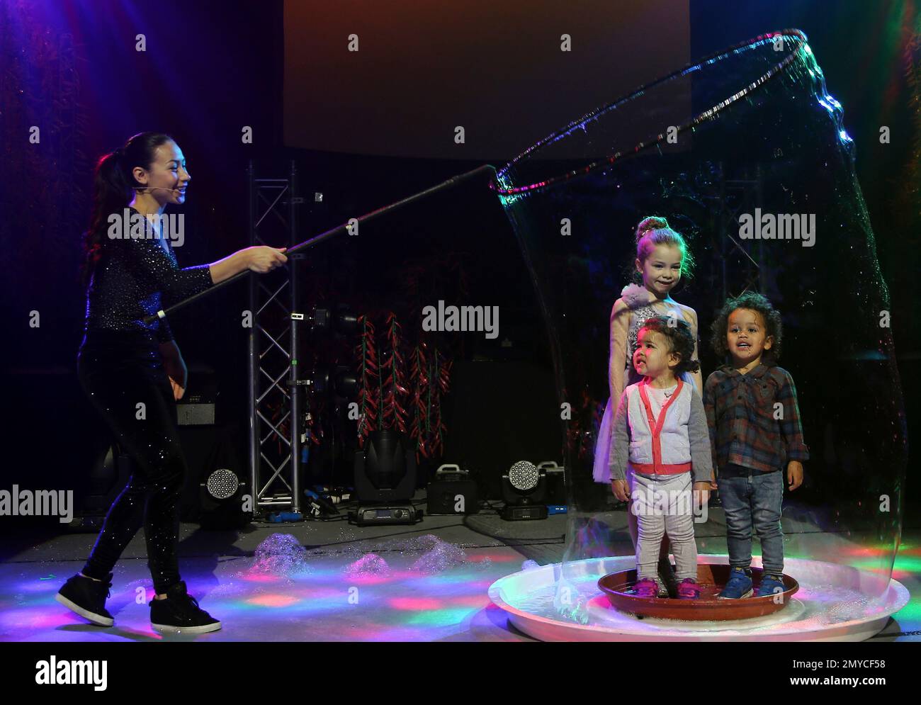 Melody Yang, left, creates a bubble over three children from the ...
