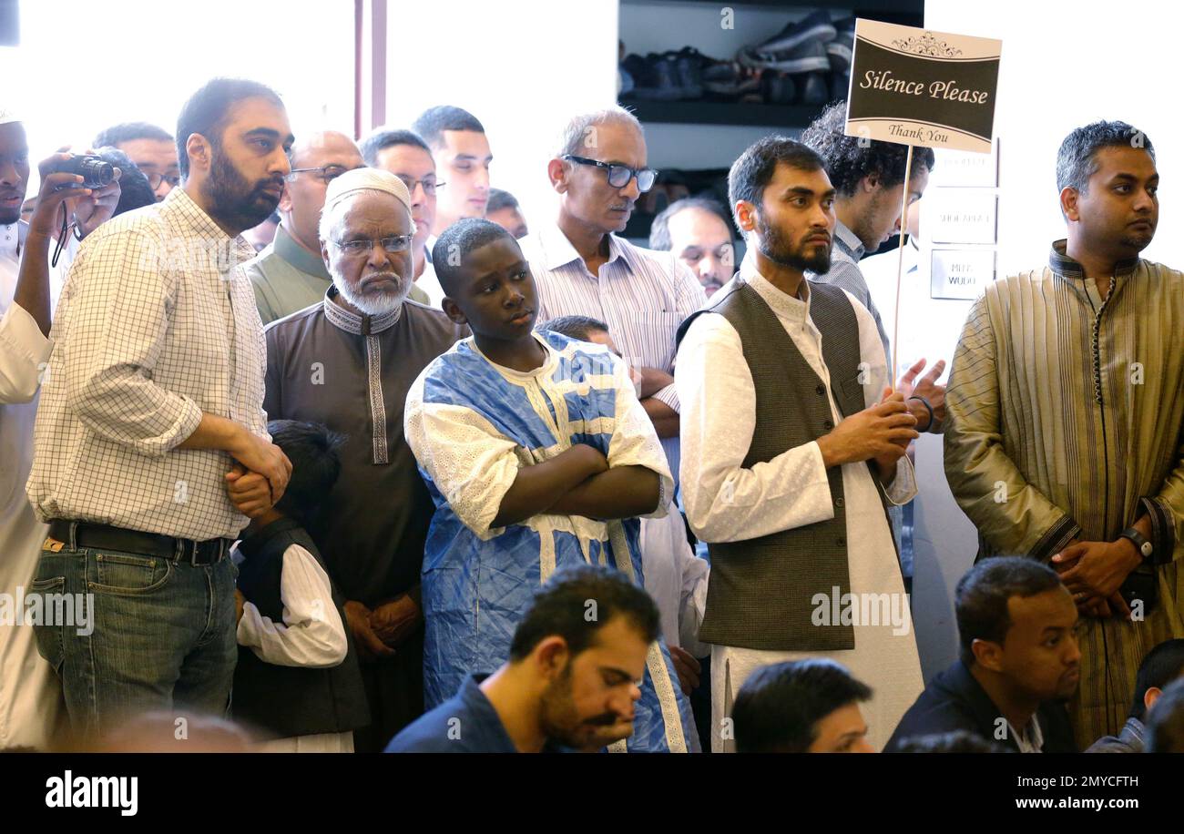 Men stand in a doorway during a prayer service at the Muslim ...