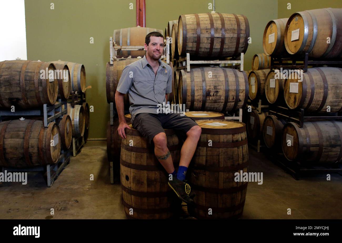 Hops & Grain owner Josh Hare poses with fermentation barrels at his ...