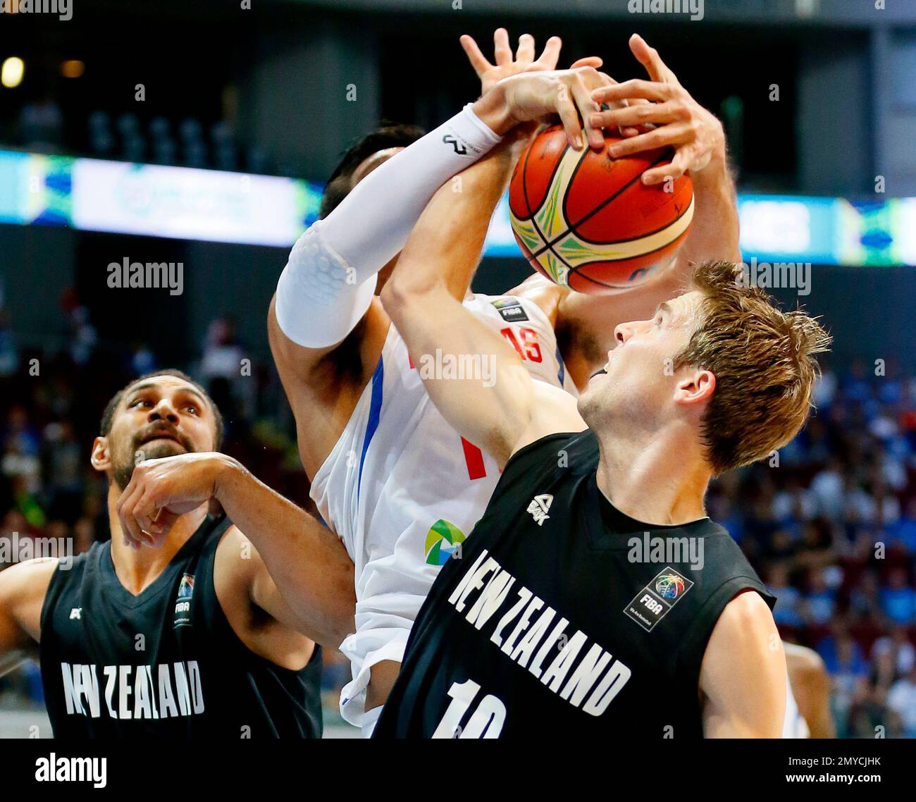 The Philippines Jun Mar Fajardo, center, battles for ball possession ...